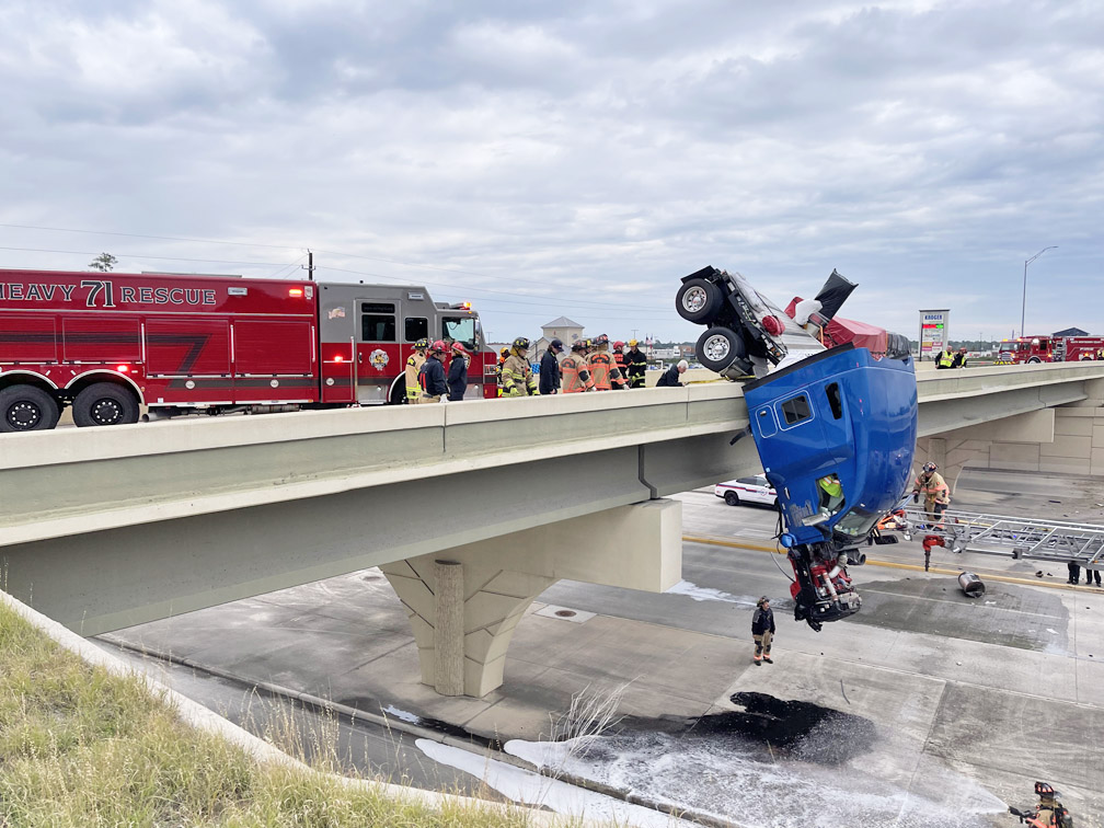 Driver rescued from big rig dangling over Texas bridge - TheTrucker.com