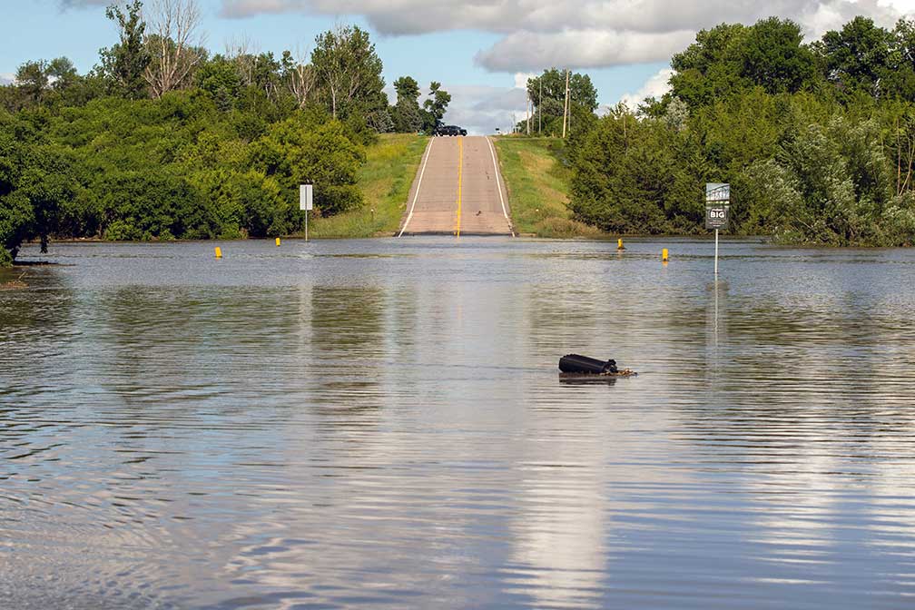 Rail bridge collapses during Midwest flooding as a heat wave persists ...